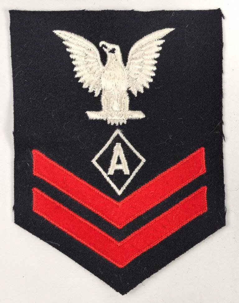 U.S. Navy rating arm badge " A" on dark blue backing, 15,00