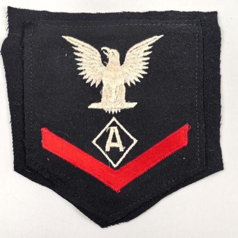 U.S. Navy rating arm badge " A" on dark blue backing, cut from shirt,